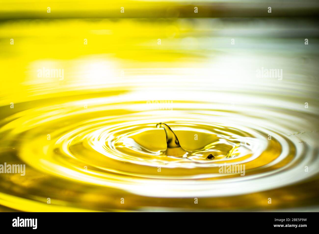 Yellow splash on water Stock Photo - Alamy