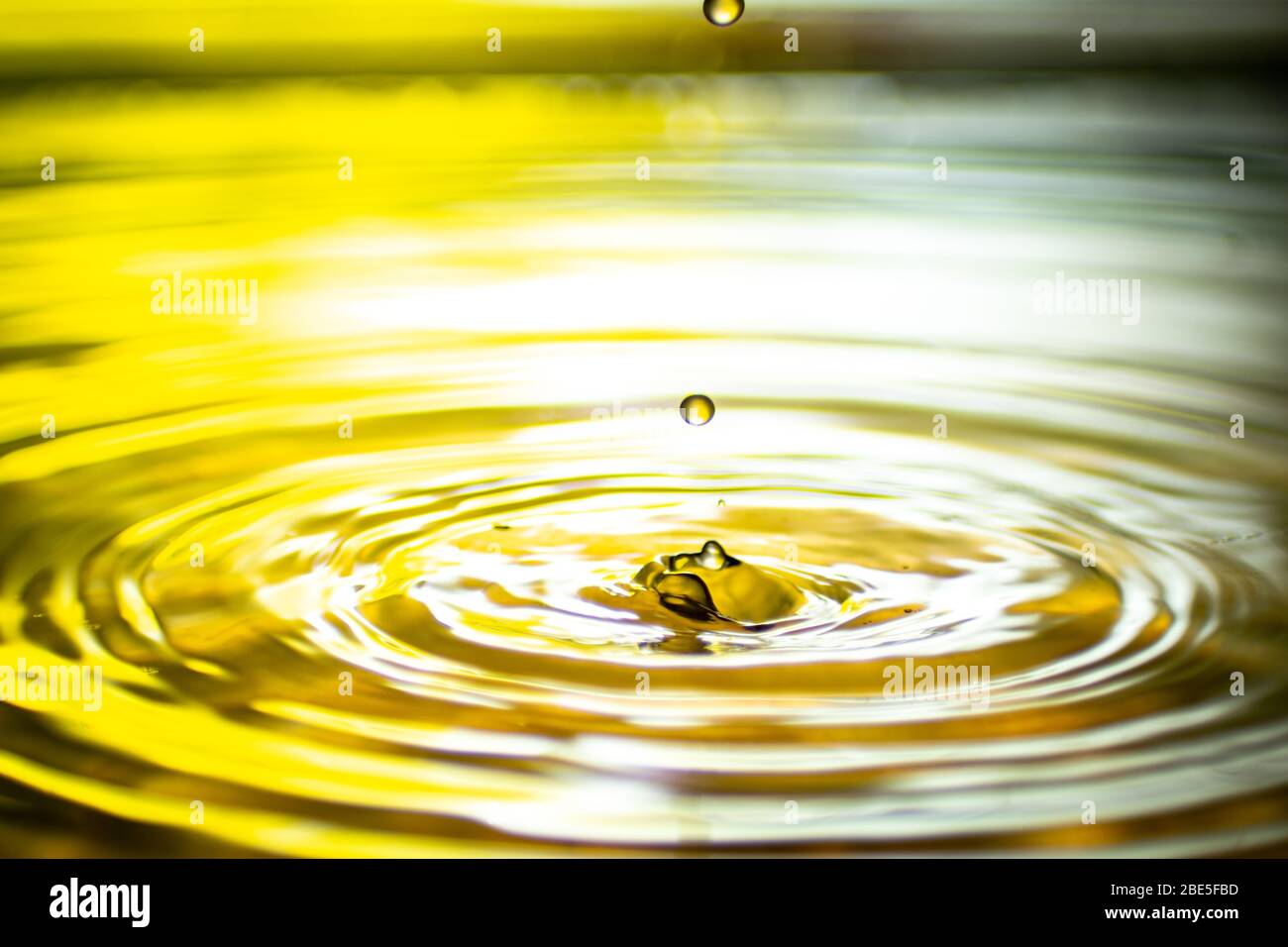 Yellow splash on water Stock Photo - Alamy