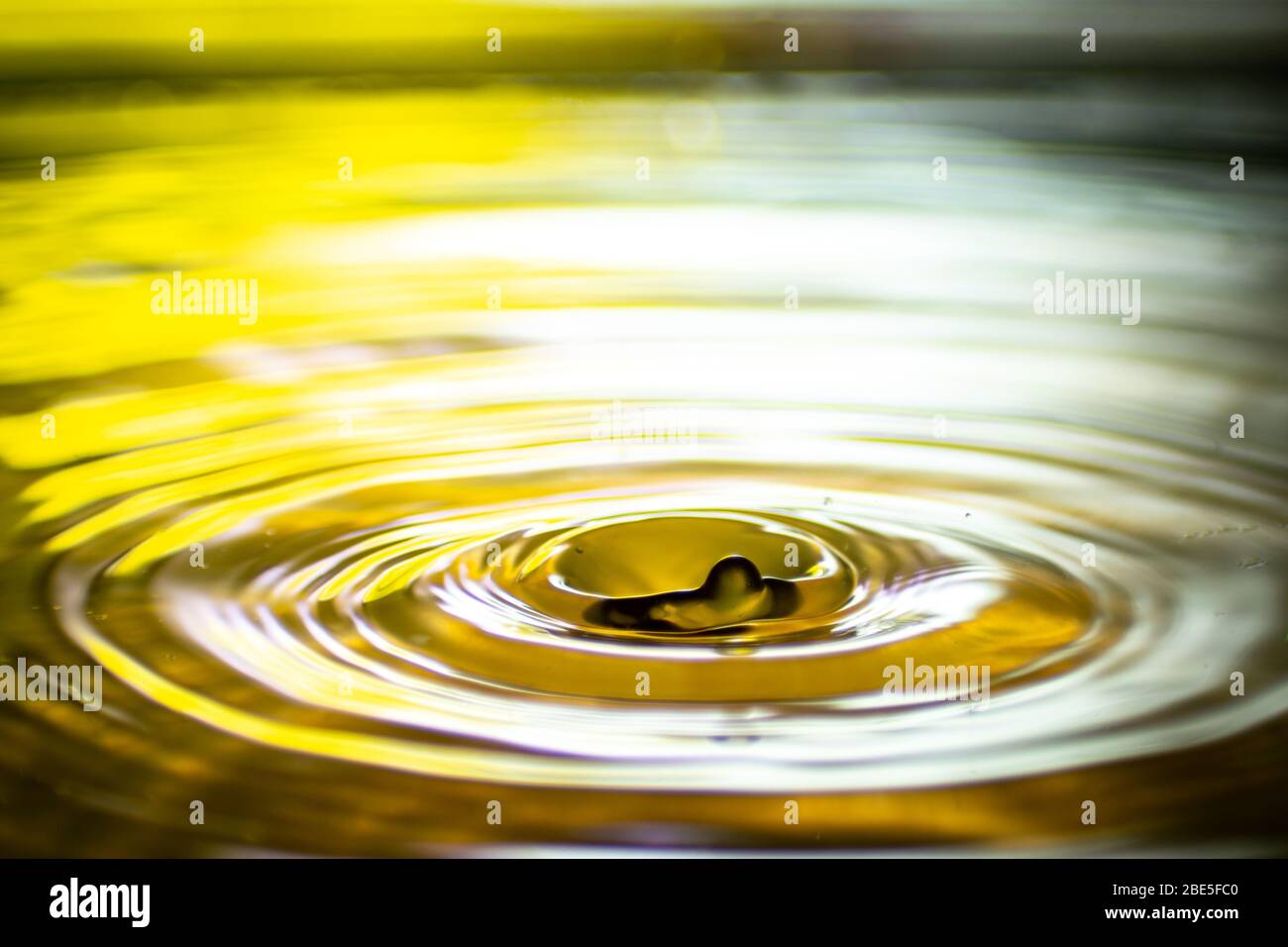 Yellow splash on water Stock Photo - Alamy