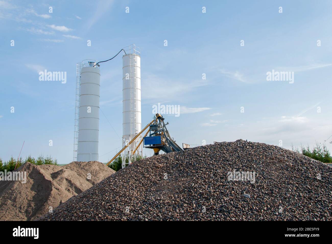 Silo for storage of cement. Cement factory machinery on a clear blue ...