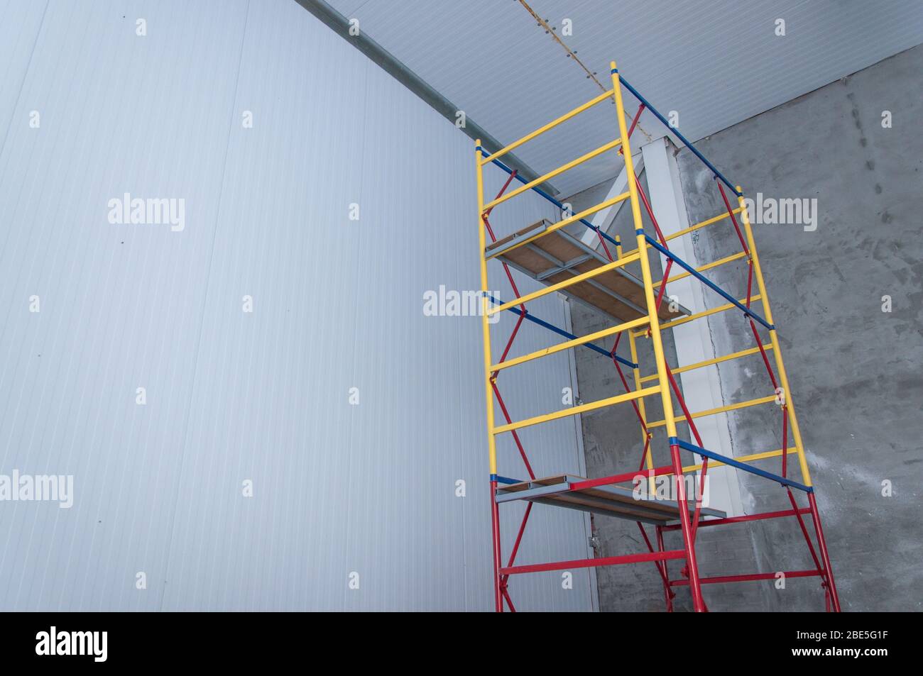 Metal scaffolding in a building under construction. Equipment for ...