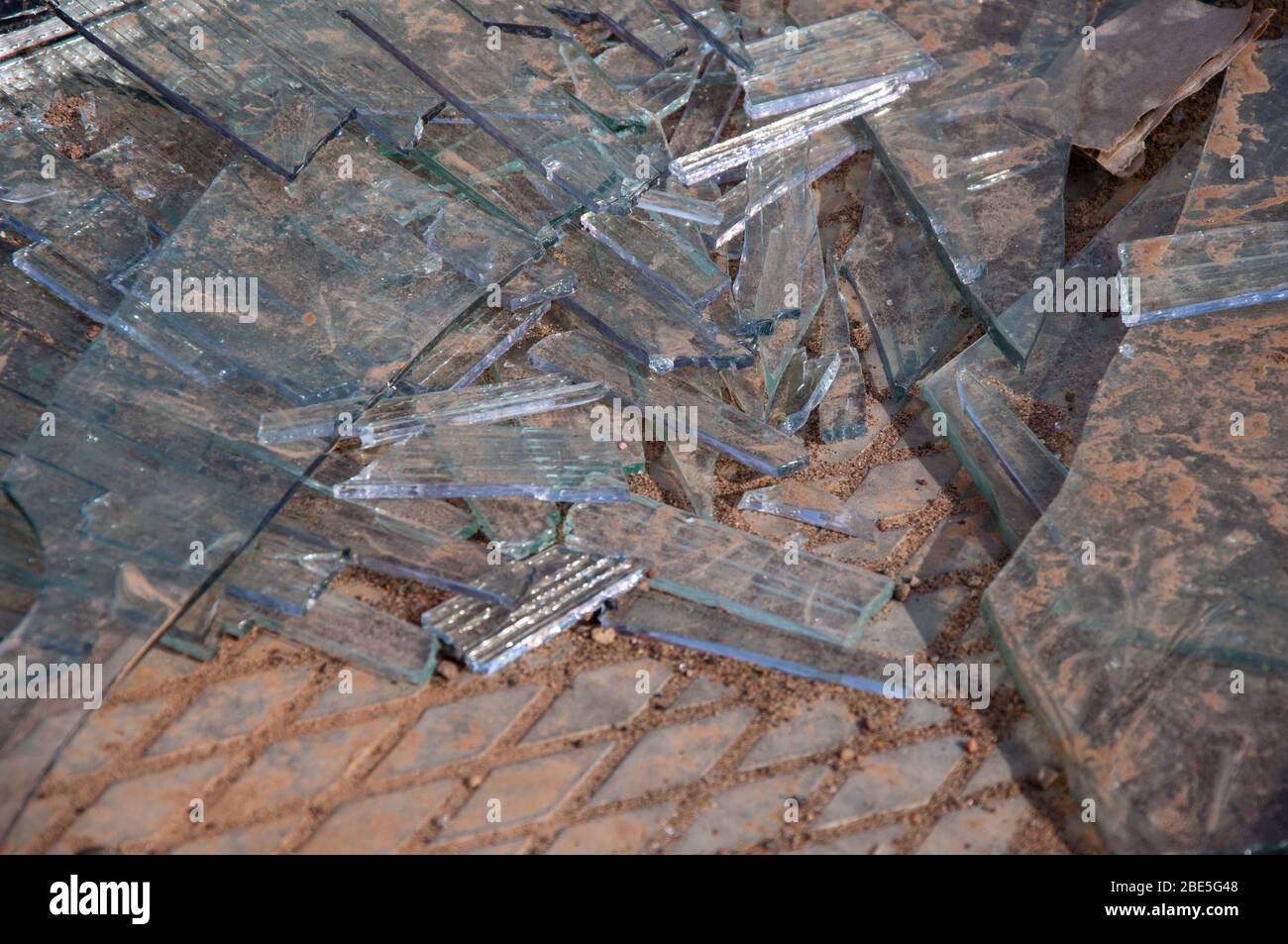 Shattered glass on a concrete slab. Broken glass. Broken window Stock ...