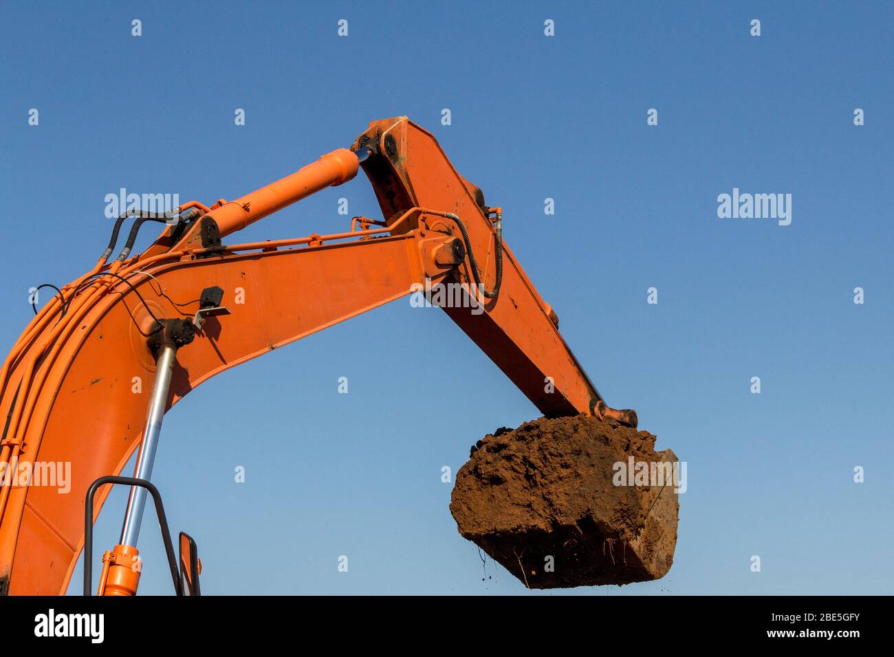 Land loading with an excavator bucket. Special construction equipment ...