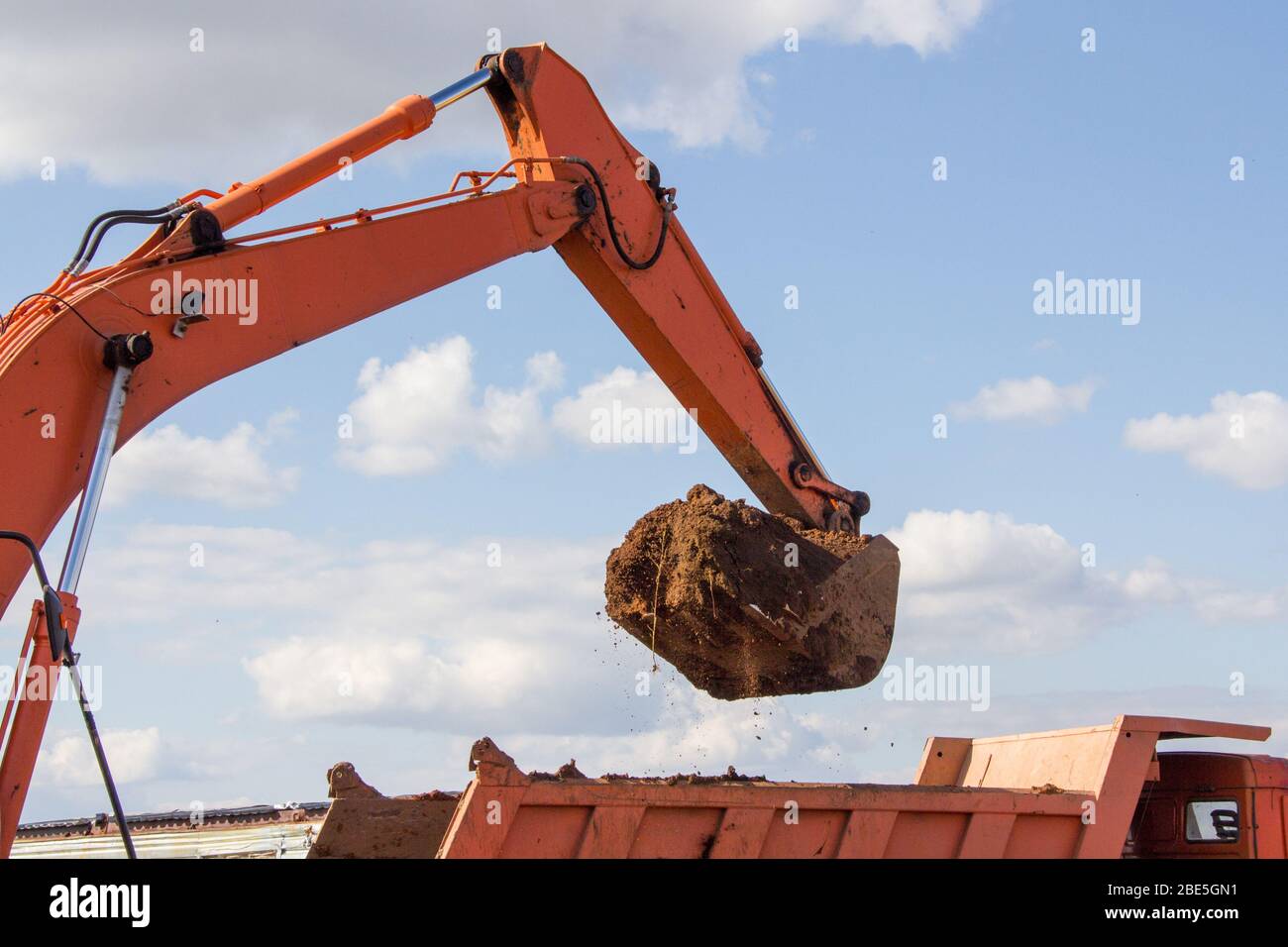 Land loading with an excavator bucket. Special construction equipment ...