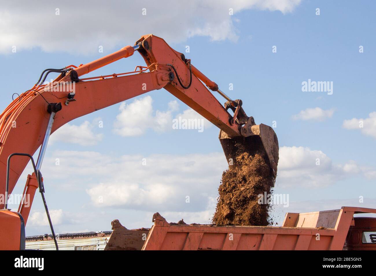 Land loading with an excavator bucket. Special construction equipment ...