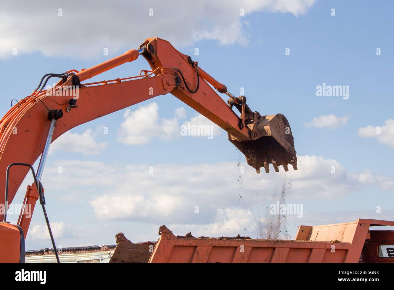 Land loading with an excavator bucket. Special construction equipment ...