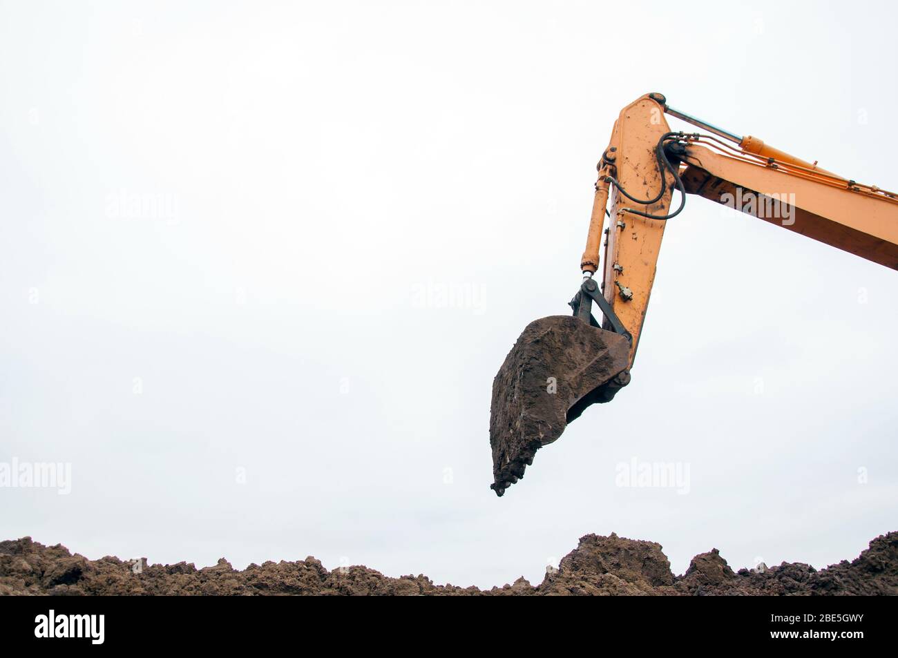 Construction excavator bucket at earthworks. Digging and land planning ...
