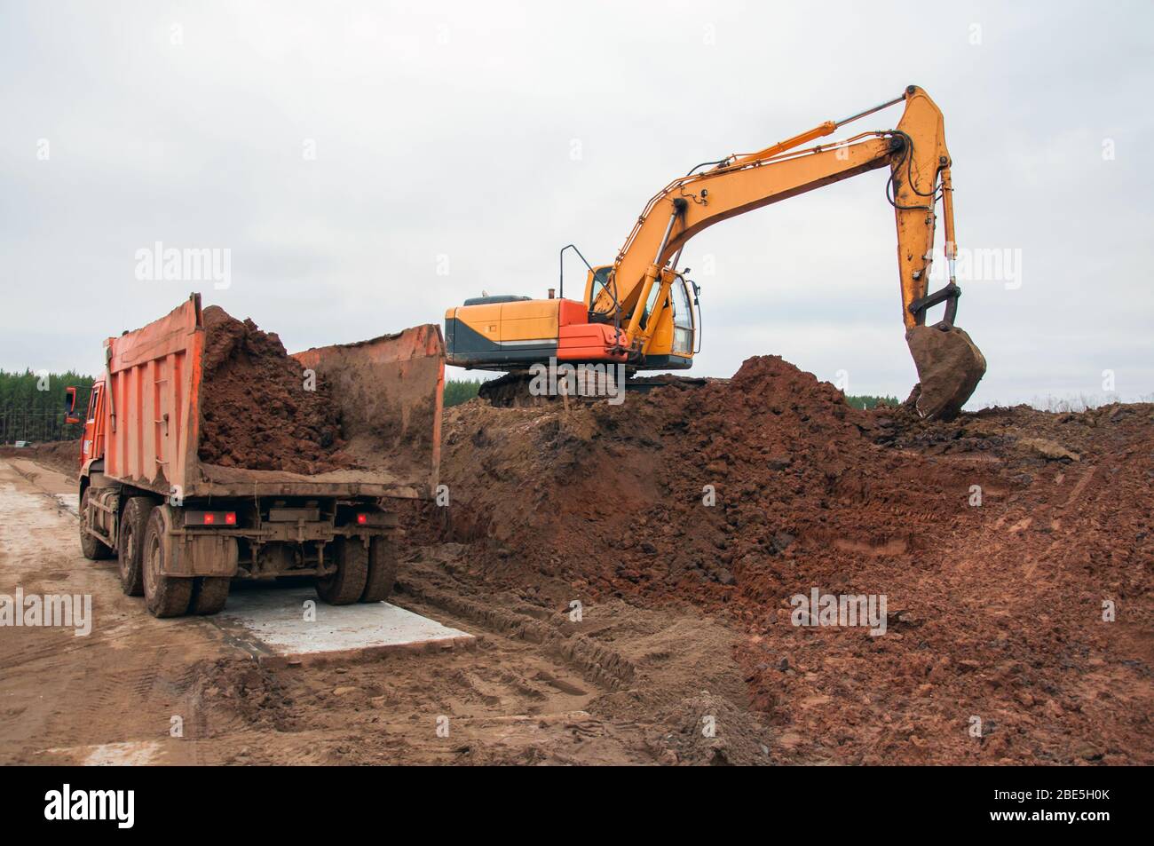 Construction excavator at earthworks. Digging and land planning at a ...