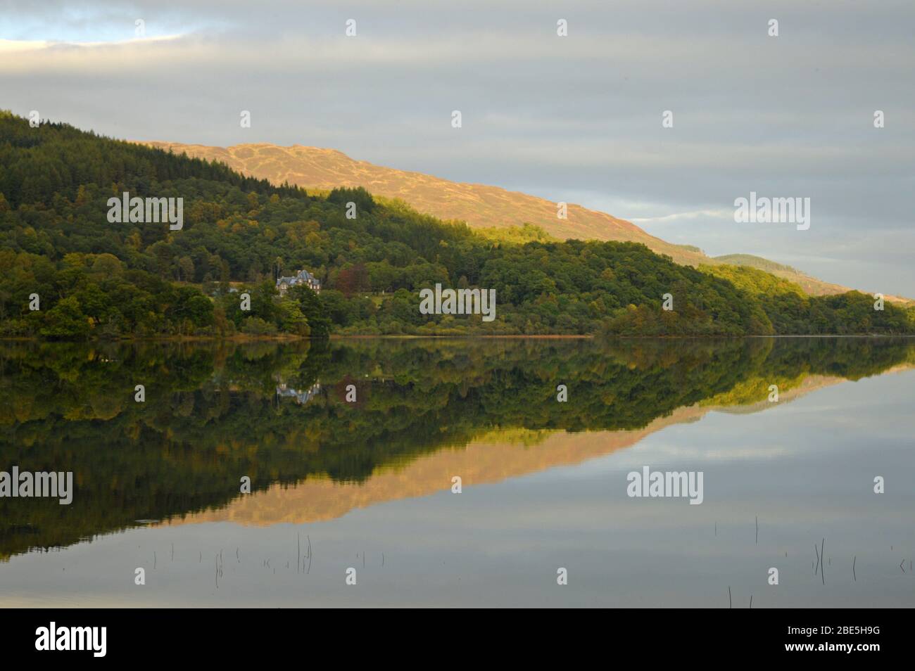 Autumn tree reflections and hotel in Loch Achray, Trossachs Scotland ...
