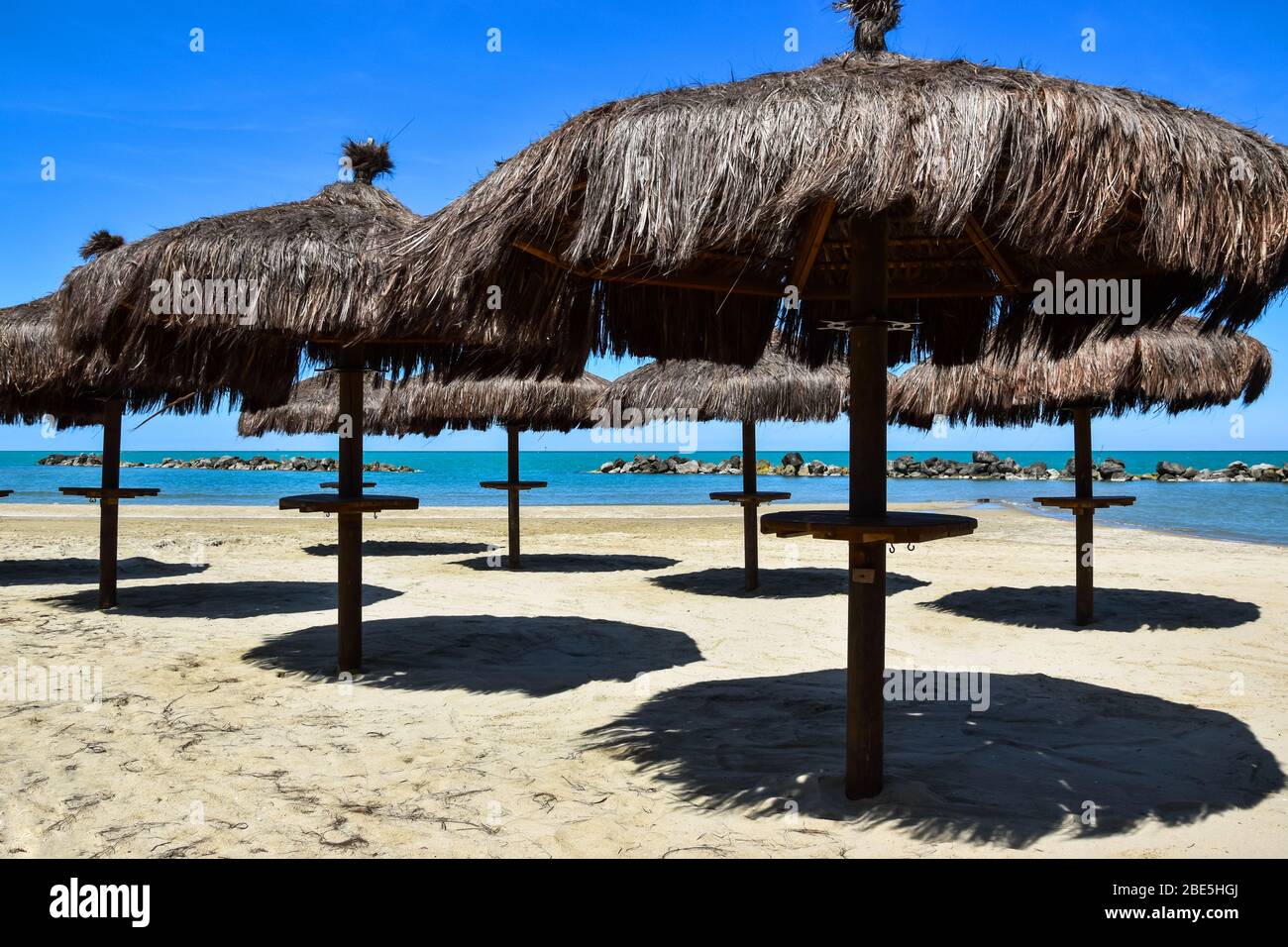 Sun protection umbrellas at the beach in Italy Stock Photo - Alamy