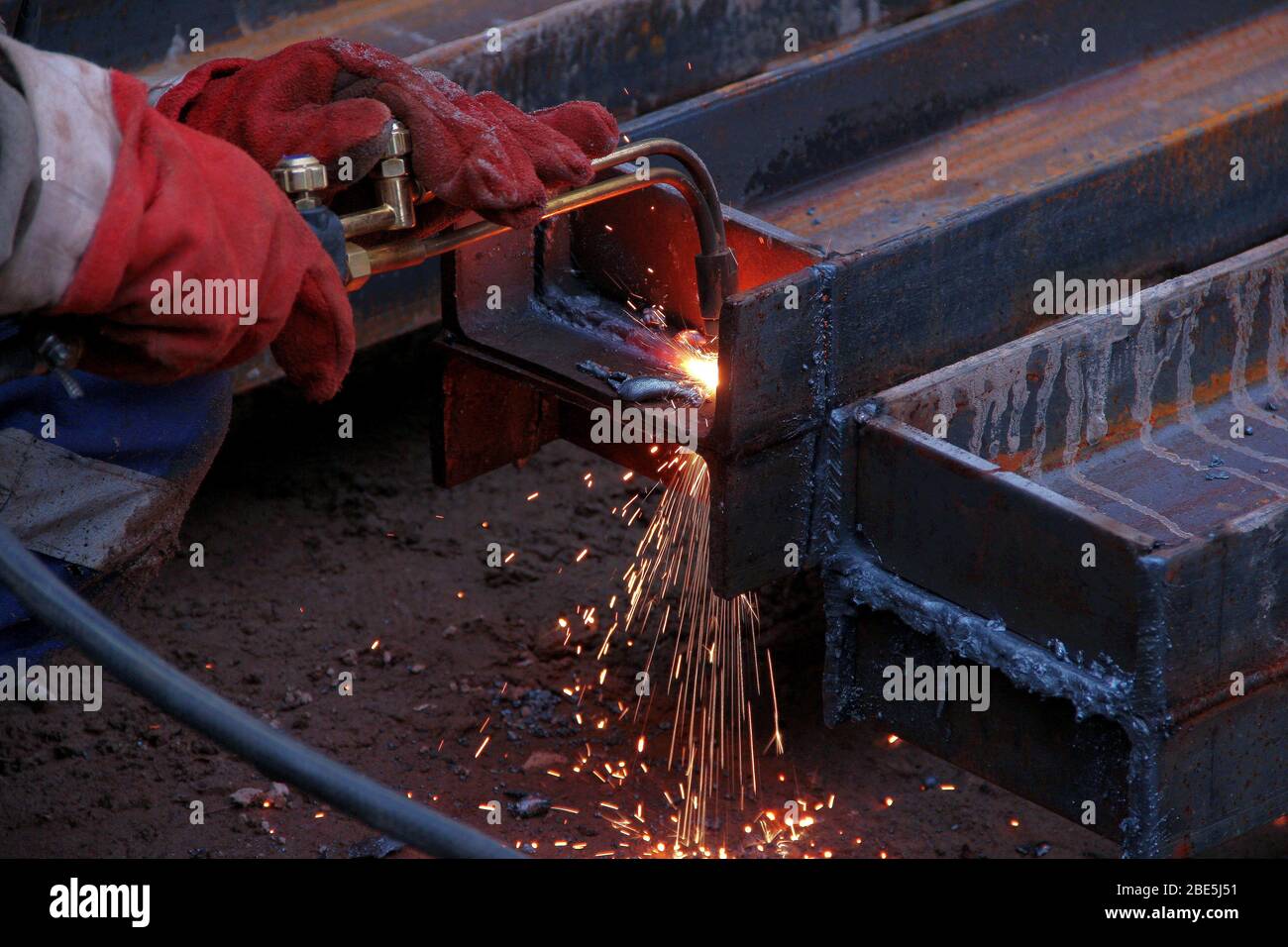 Cutting a steel beam with a gas torch. Industrial metal cutting. The ...