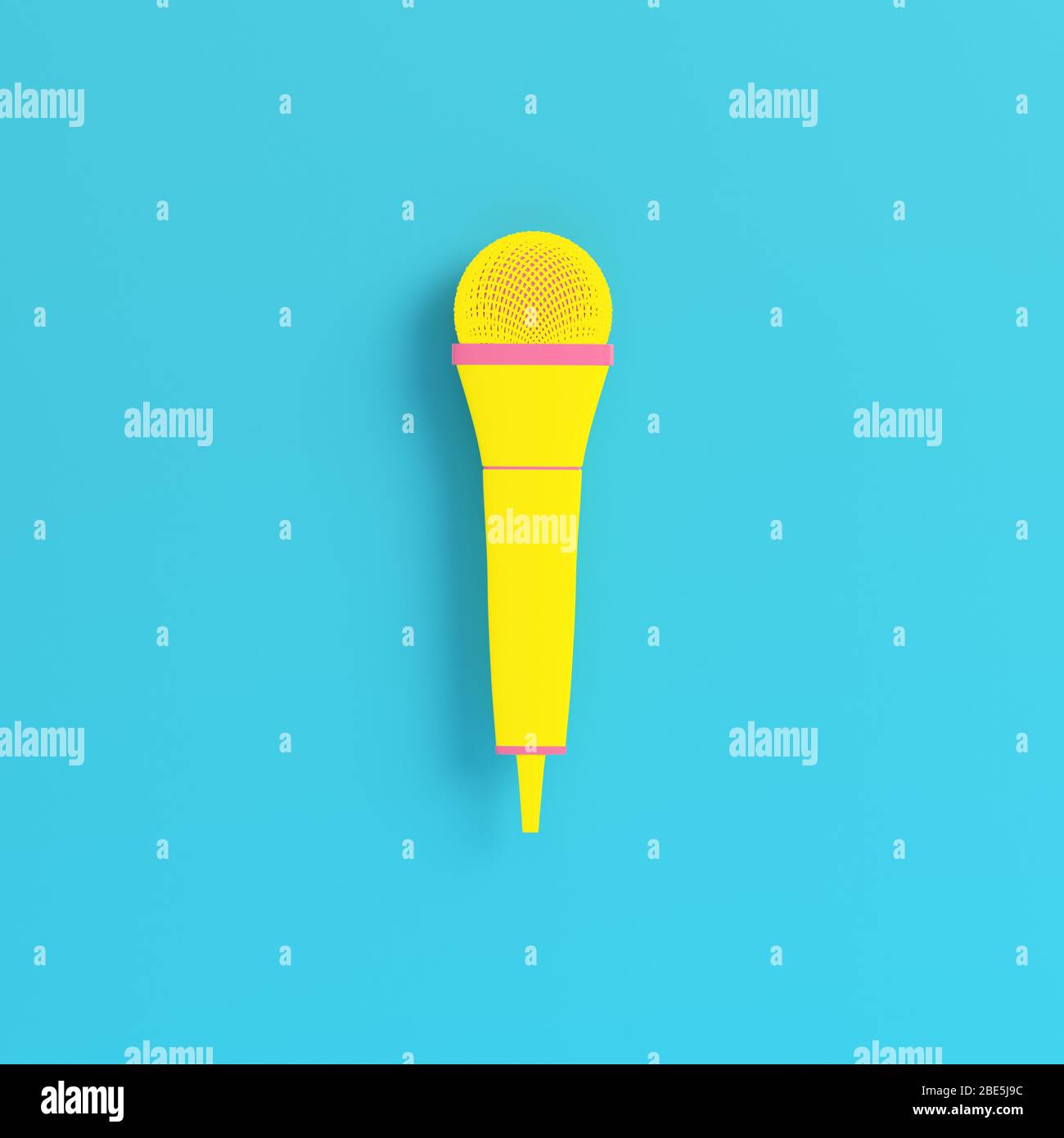 Yellow microphone on bright blue background in pastel colors ...