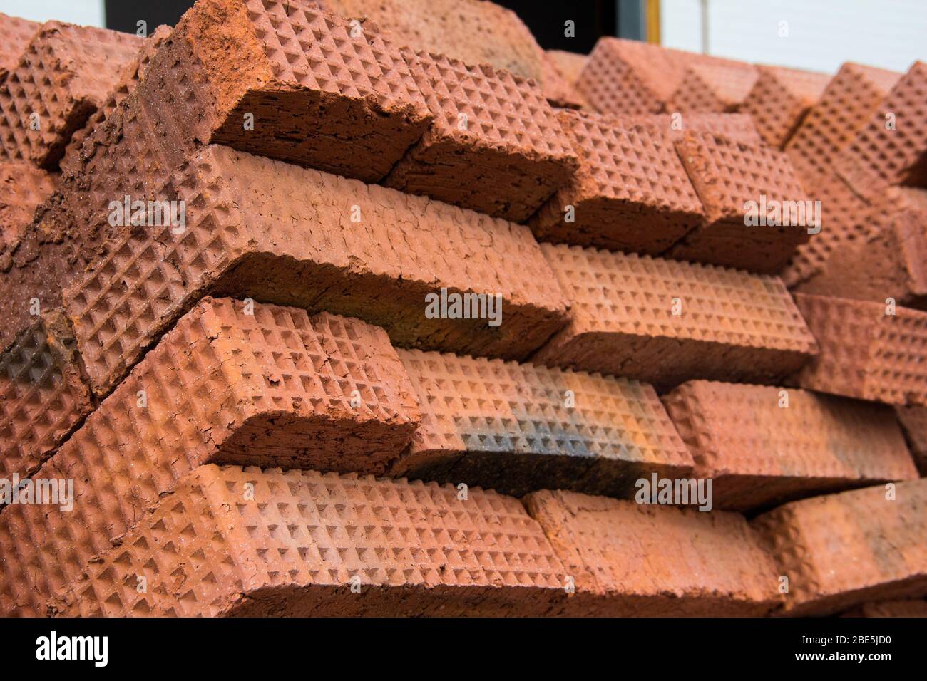 New red clay bricks for masonry building walls. Material for the ...
