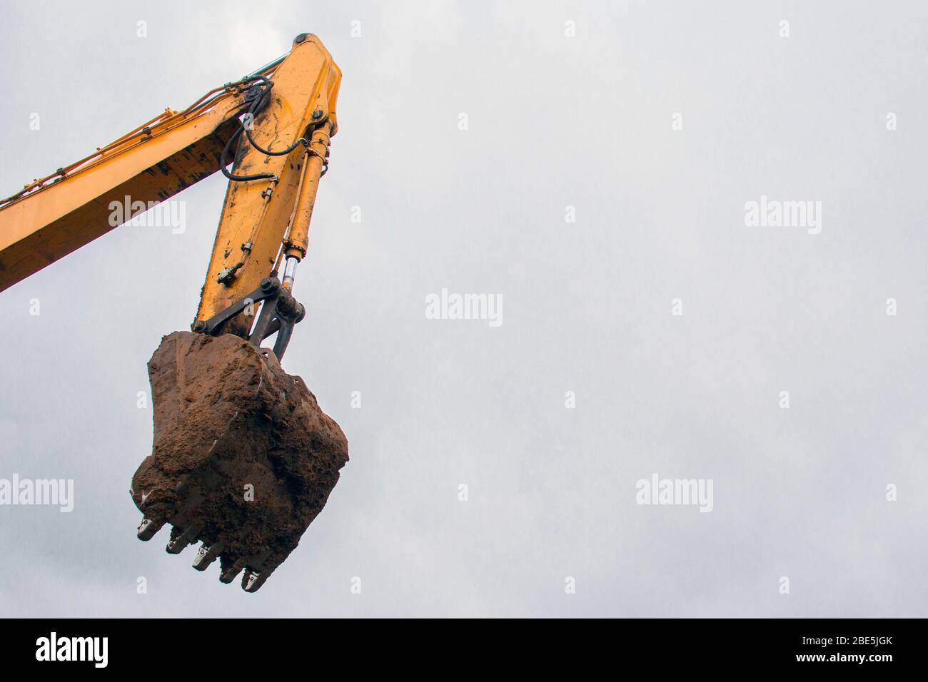Construction excavator bucket at earthworks. Digging and land planning ...
