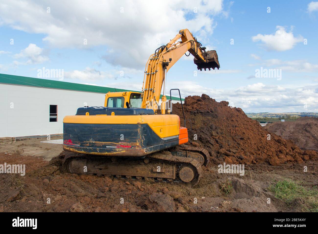 Construction excavator at earthworks. Digging and land planning at a ...