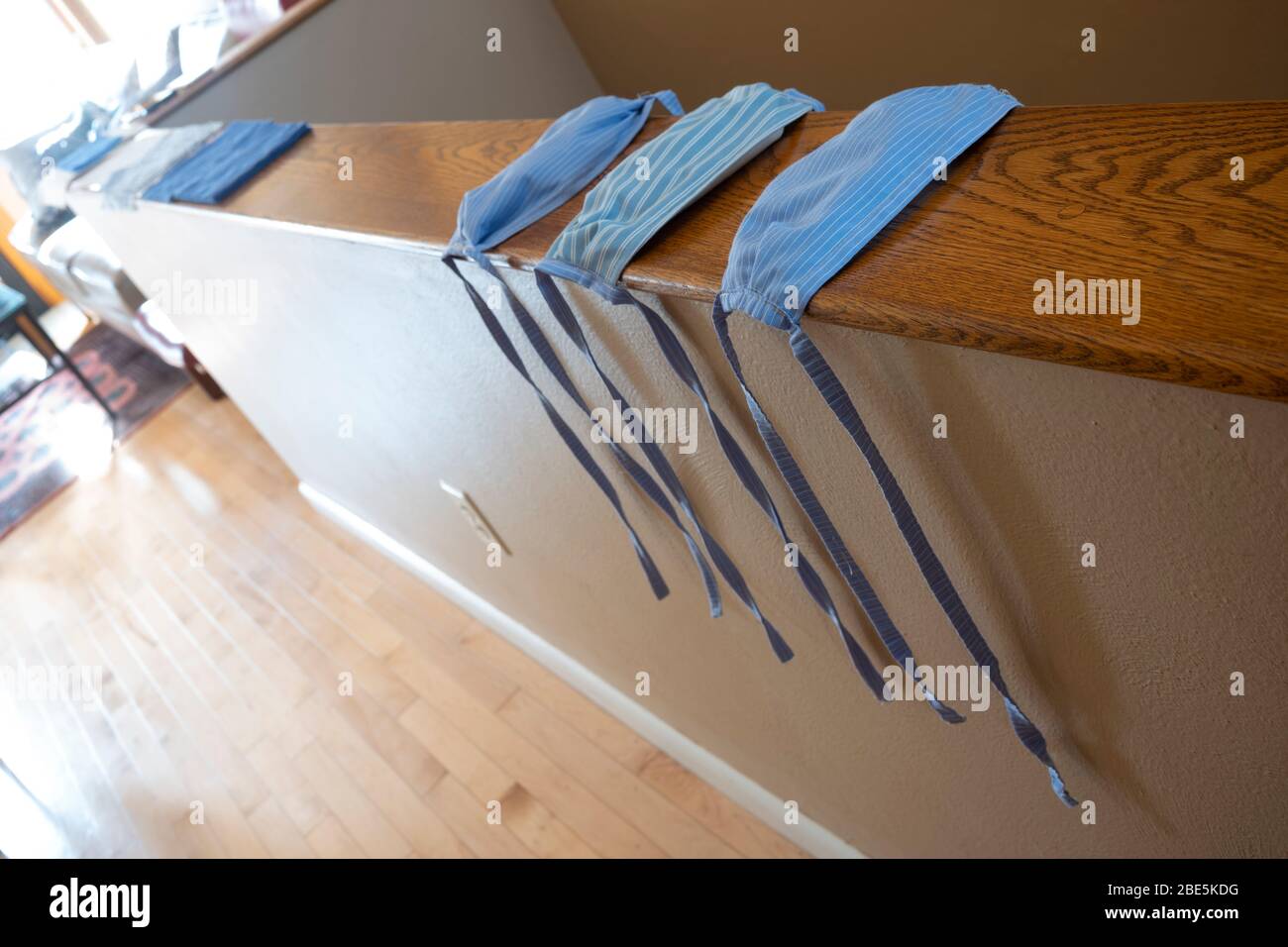 A close-up of three, hand-sewn face masks that were made from blue ...