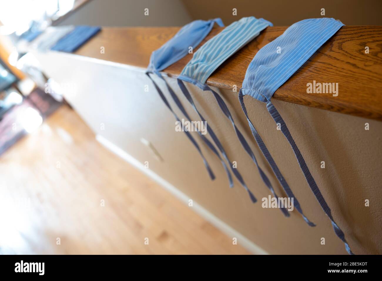 A close-up of three, hand-sewn face masks that were made from blue ...