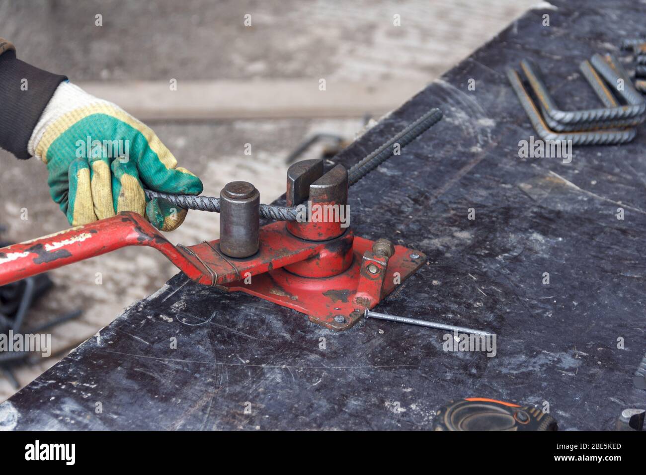 Bending reinforcement metal rebar. Worker using bending rebar machine ...