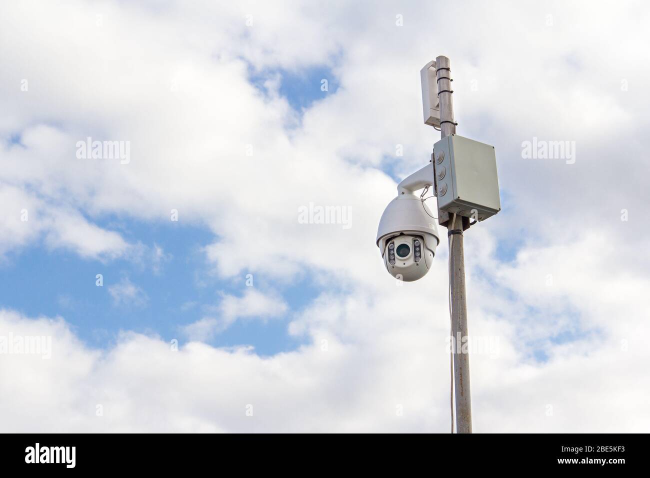 Security Camera on a blue sky background. Surveillance camera for ...