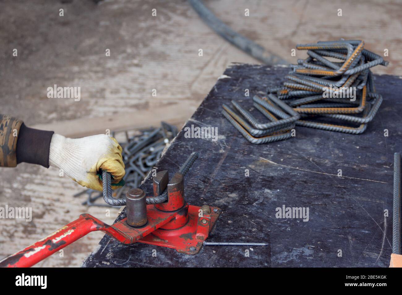 Bending reinforcement metal rebar. Worker using bending rebar machine ...