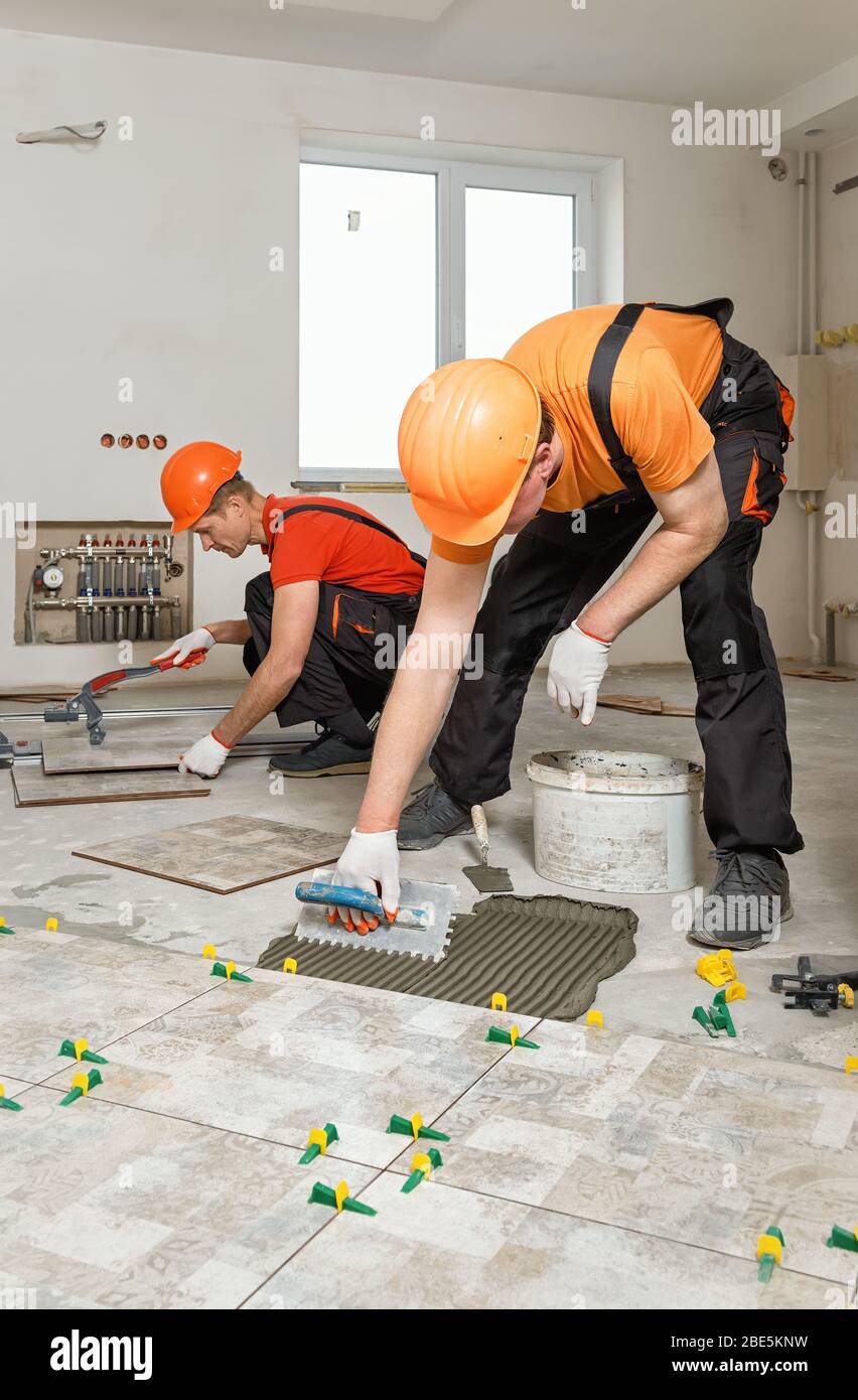 Construction workers laying tile hi-res stock photography and images ...
