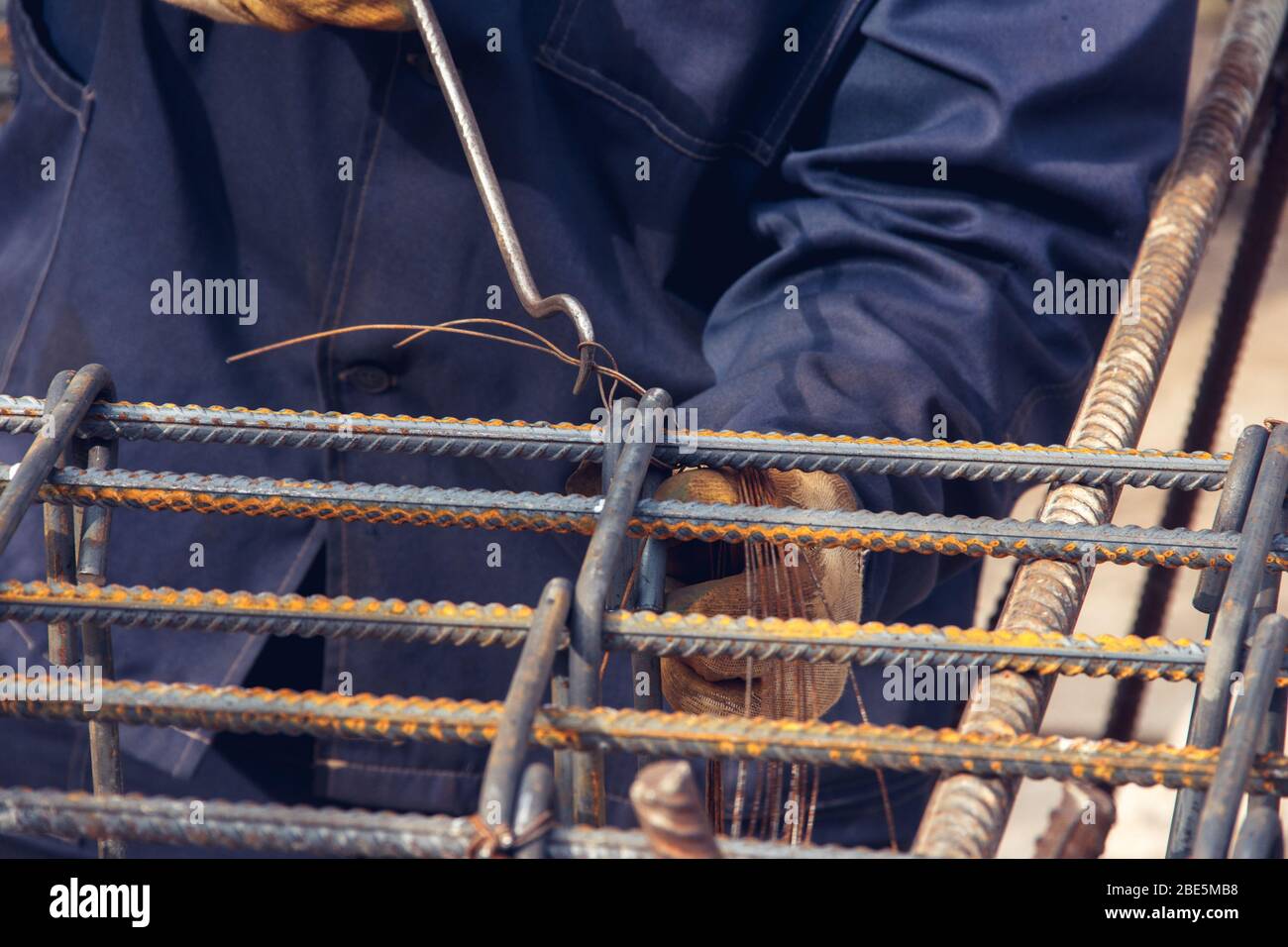 Assembly of reinforcing bars for pouring concrete. Construction worker ...