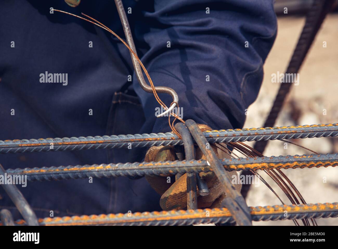 Assembly of reinforcing bars for pouring concrete. Construction worker ...