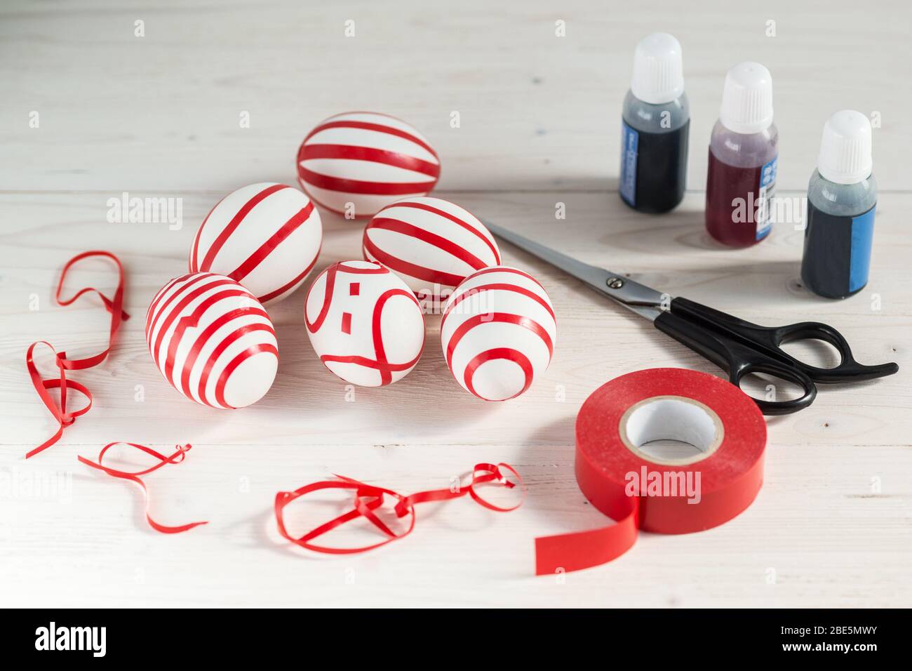 Coloring eggs for the chrestian holiday of Easter using adhesive tape ...