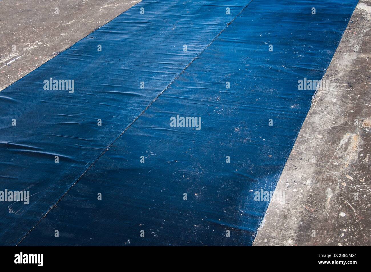 Installing new waterproofing materials on the roof. Installation of ...