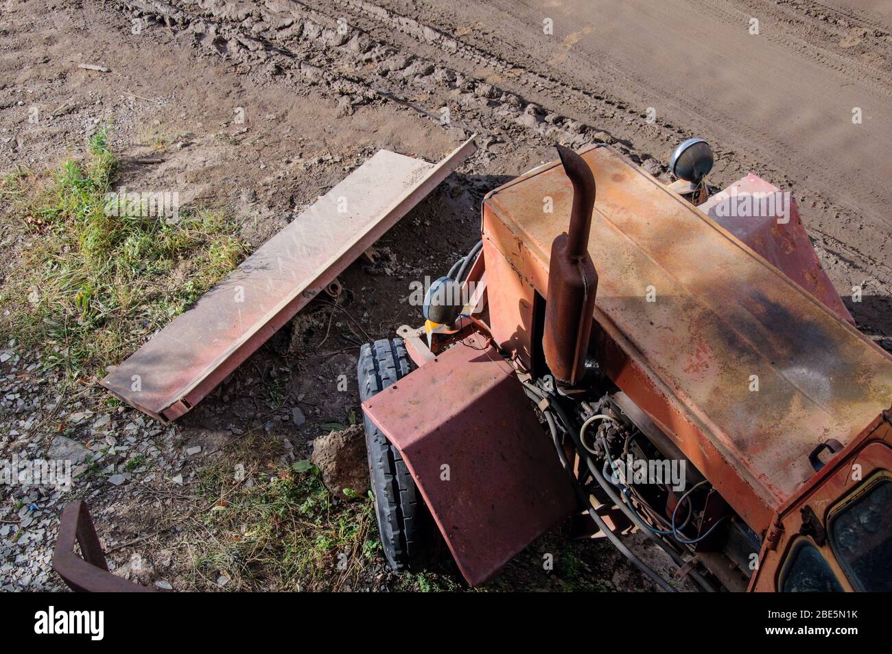 Top view on an old rusting tractor. Abandoned spent on construction ...