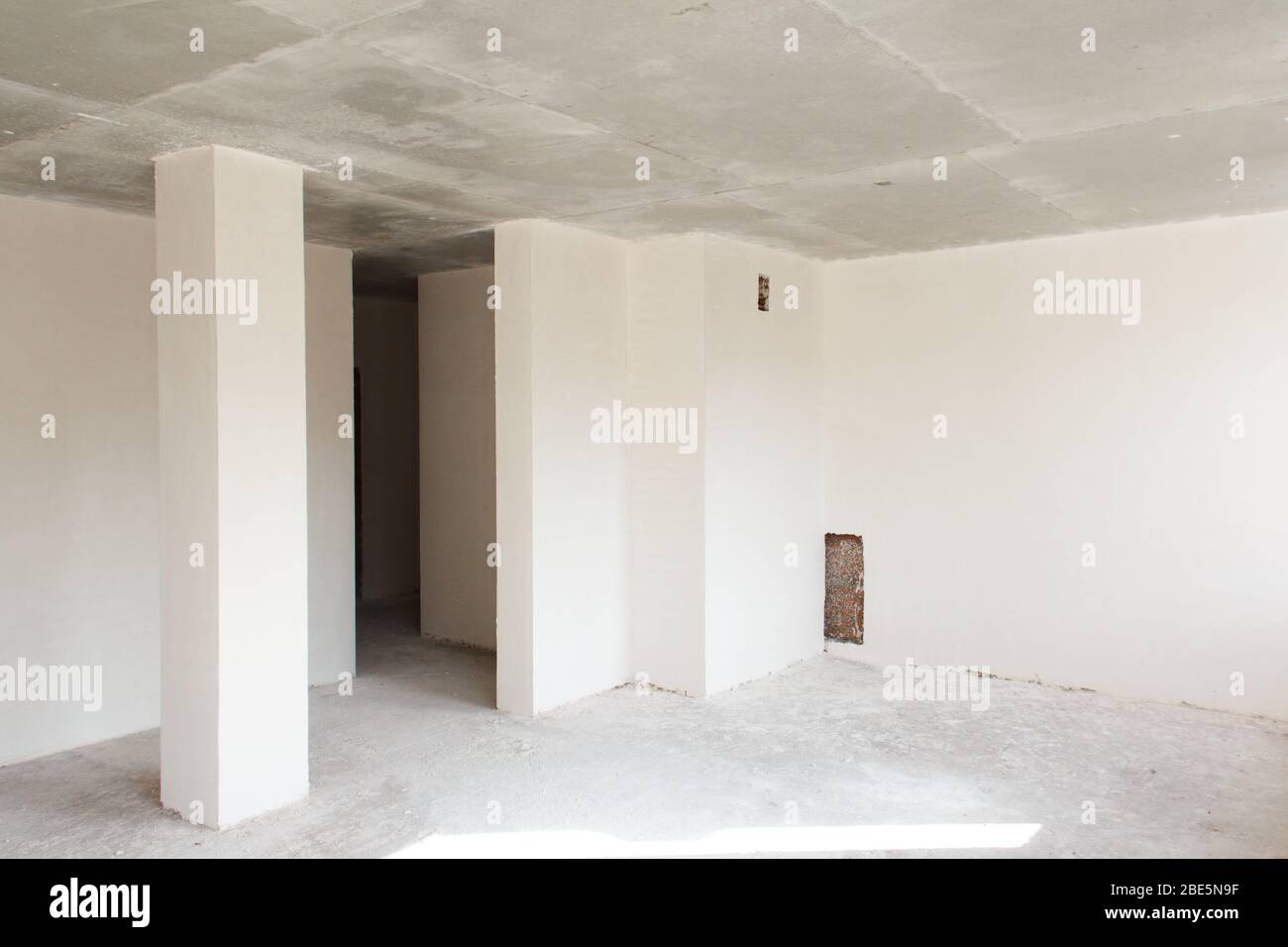 Walls covered with white stucco. New building. Preparatory work in the ...