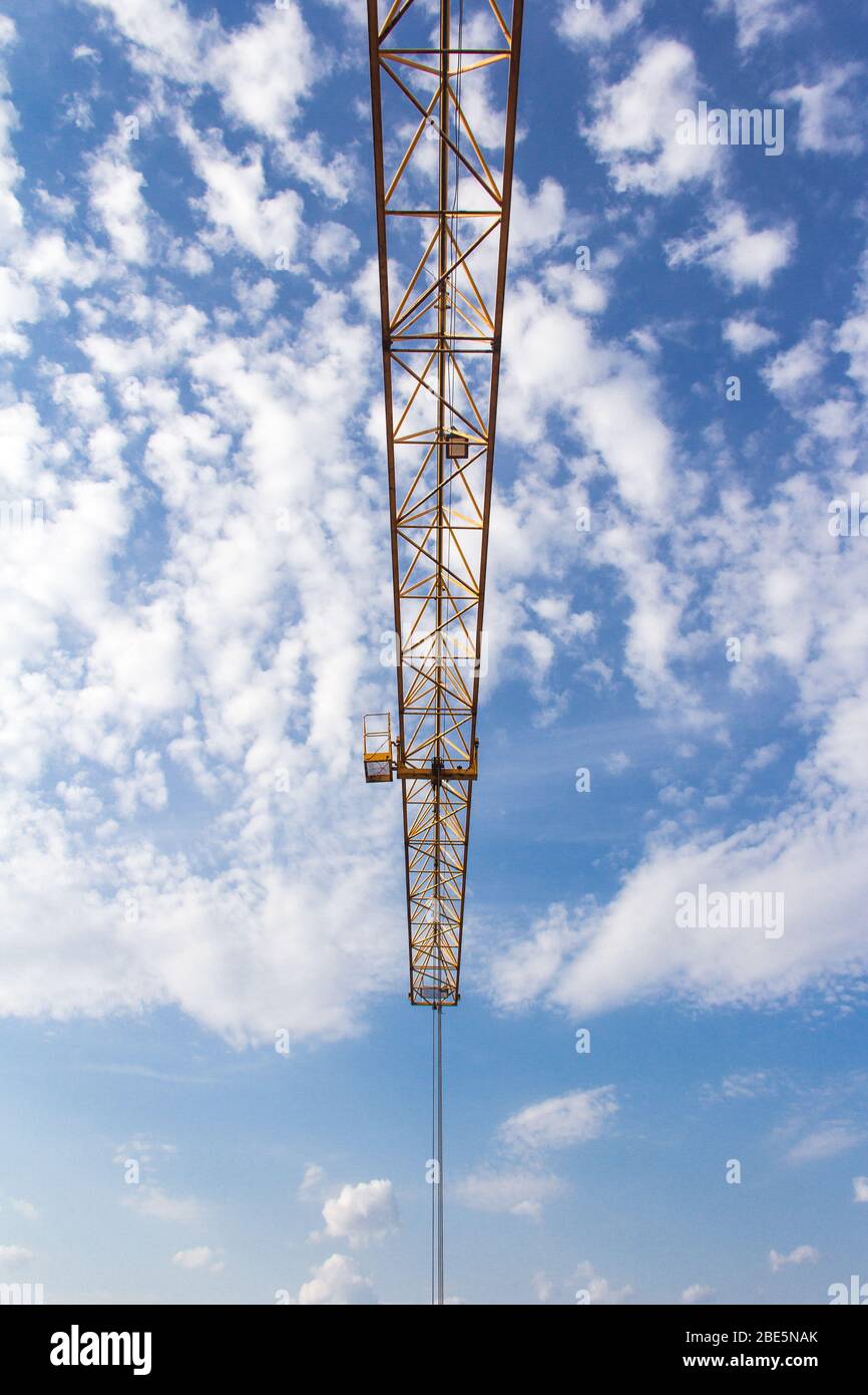 Boom tower crane against the blue sky. The mechanism for lifting goods ...