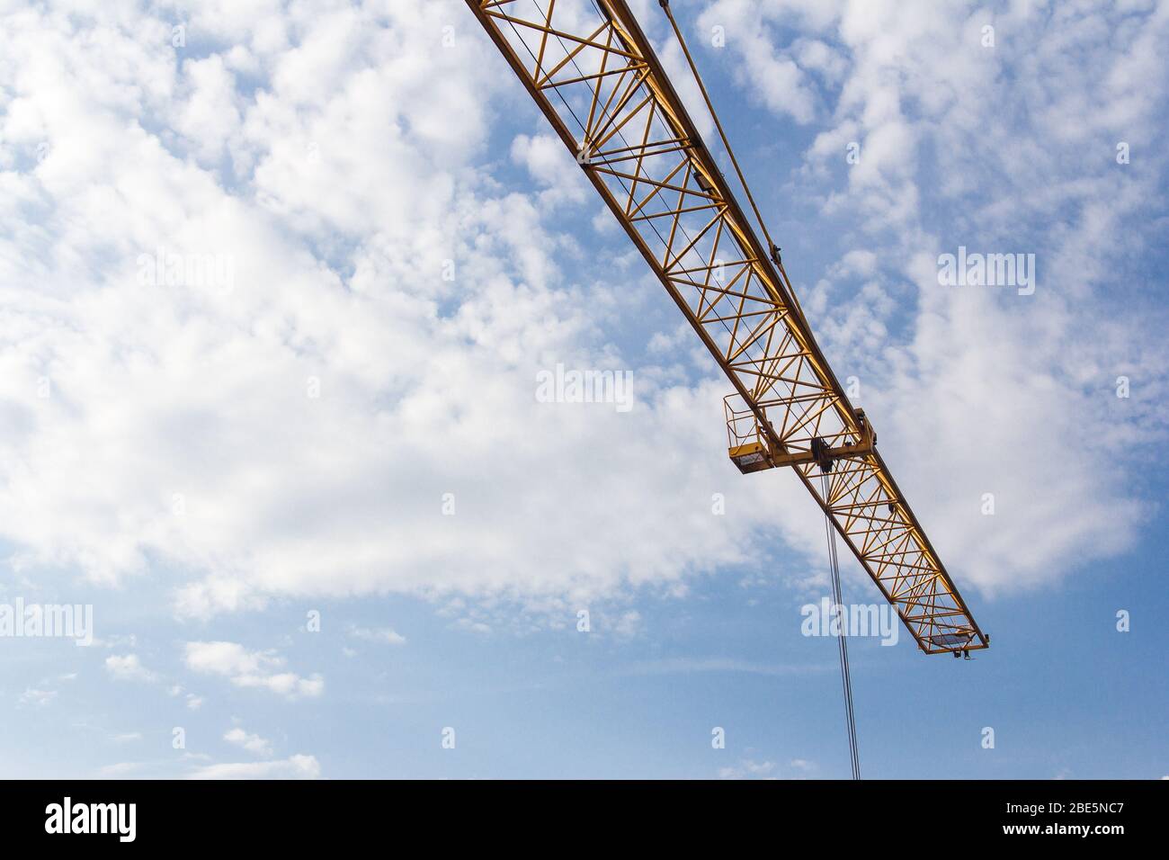 Boom tower crane against the blue sky. The mechanism for lifting goods ...