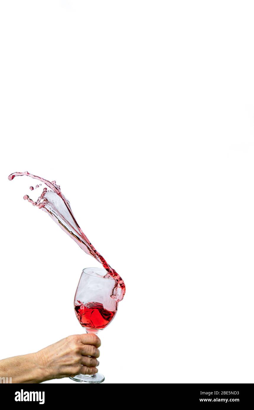 Wine splashing out of wine glass Stock Photo - Alamy