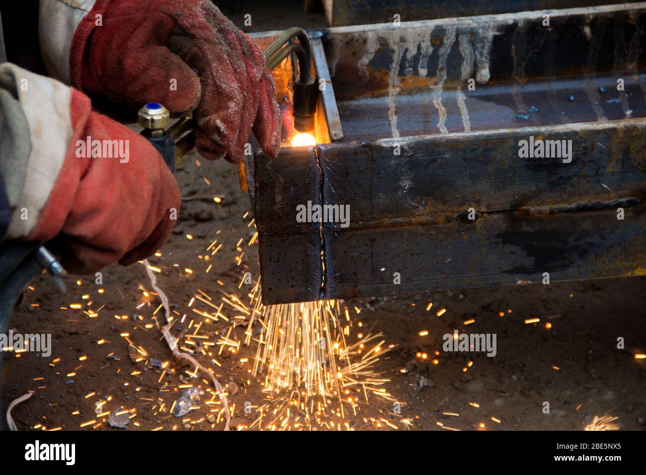 Cutting a steel beam with a gas torch. Industrial metal cutting. The ...