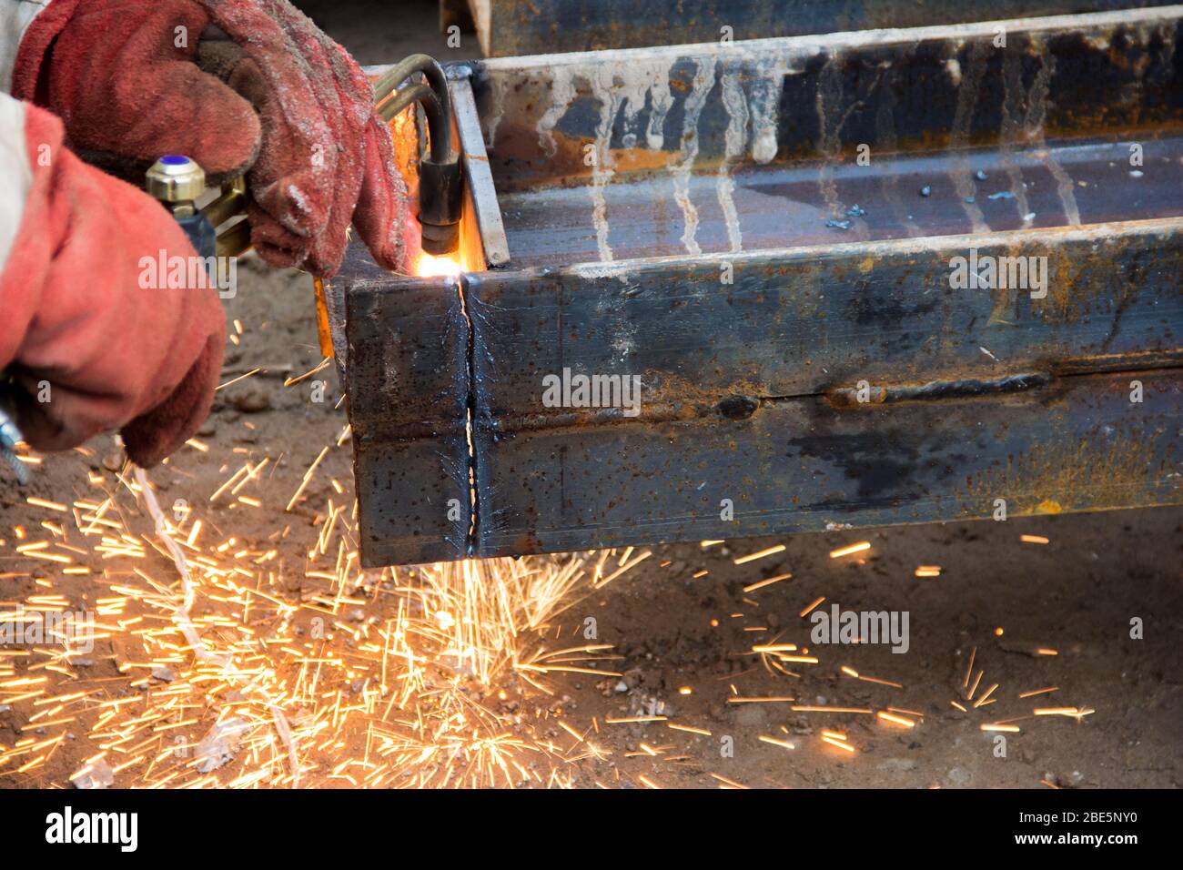 Cutting a steel beam with a gas torch. Industrial metal cutting. The ...
