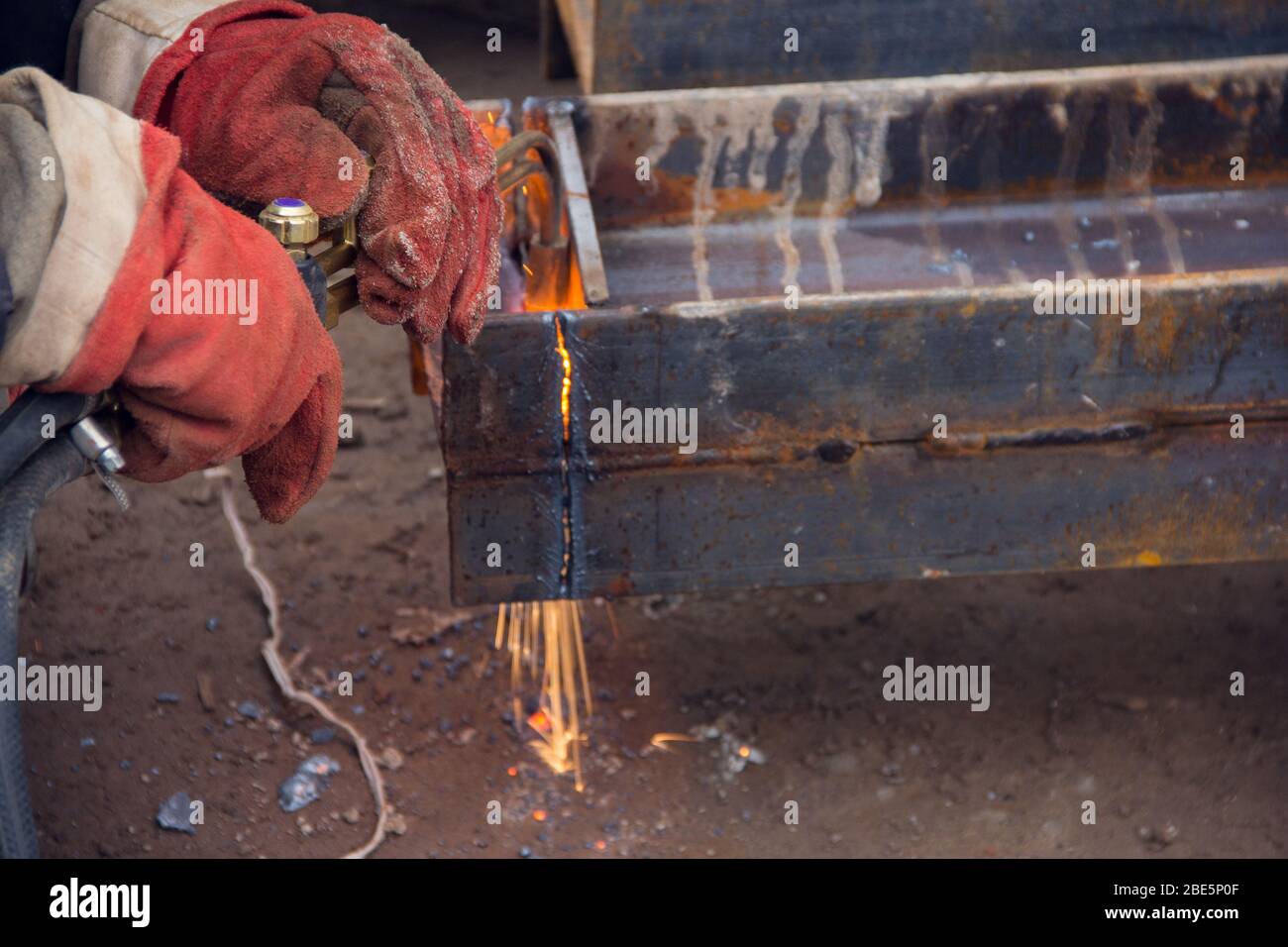 Cutting a steel beam with a gas torch. Industrial metal cutting. The ...