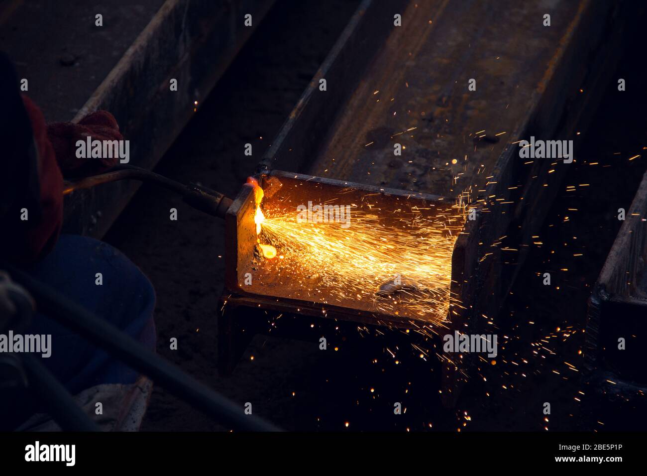 Cutting a steel beam with a gas torch. Industrial metal cutting. The ...