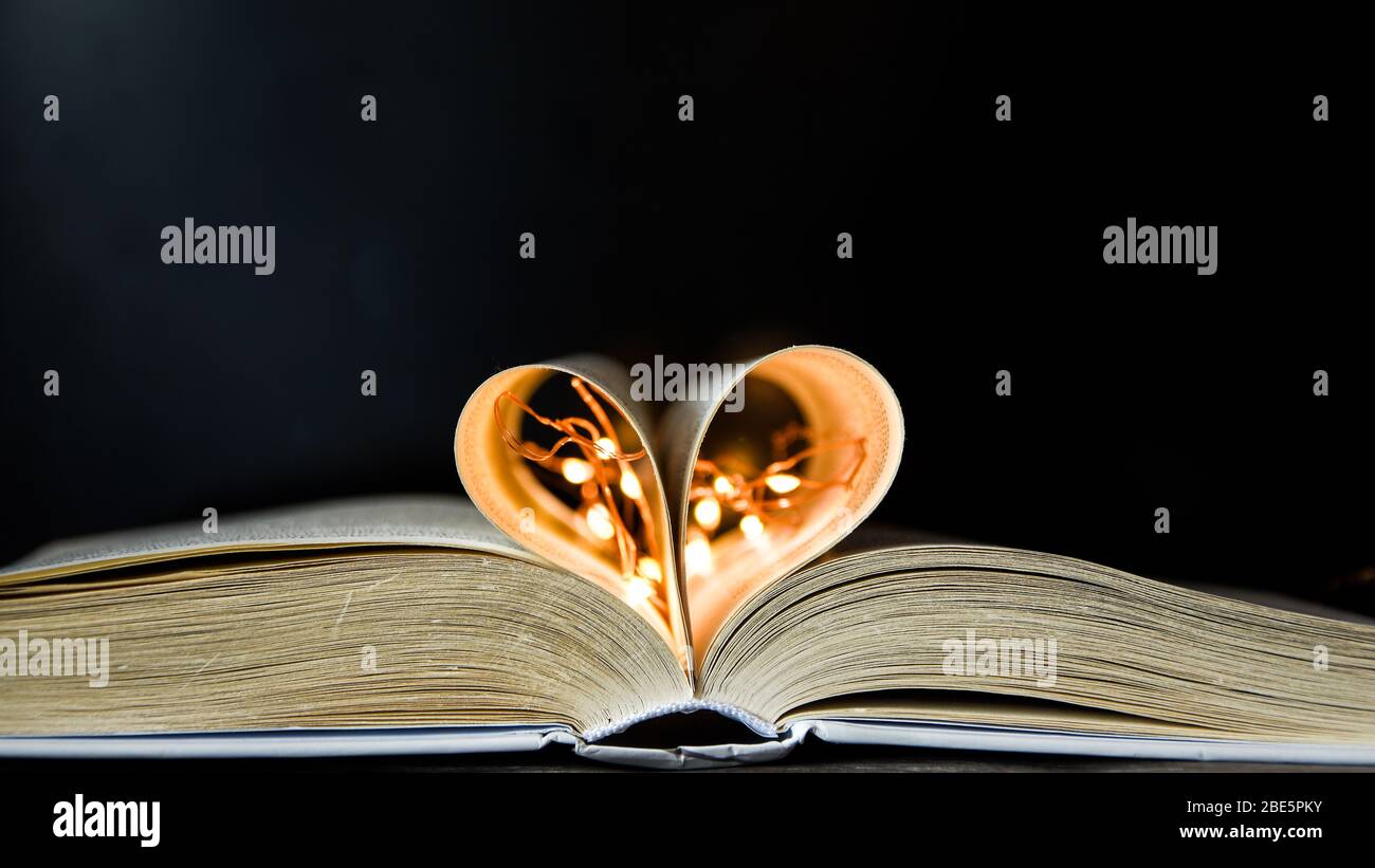 Book with love symbol isolated on black background, Close-up Of Heart ...