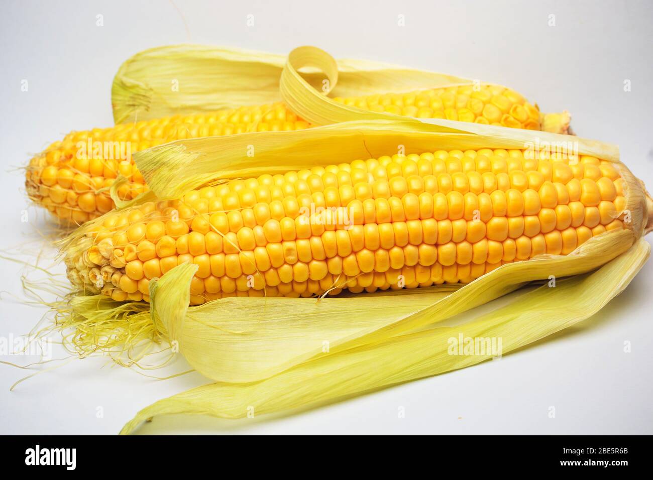 fresh corn vegetable with green leaves isolated on white background ...