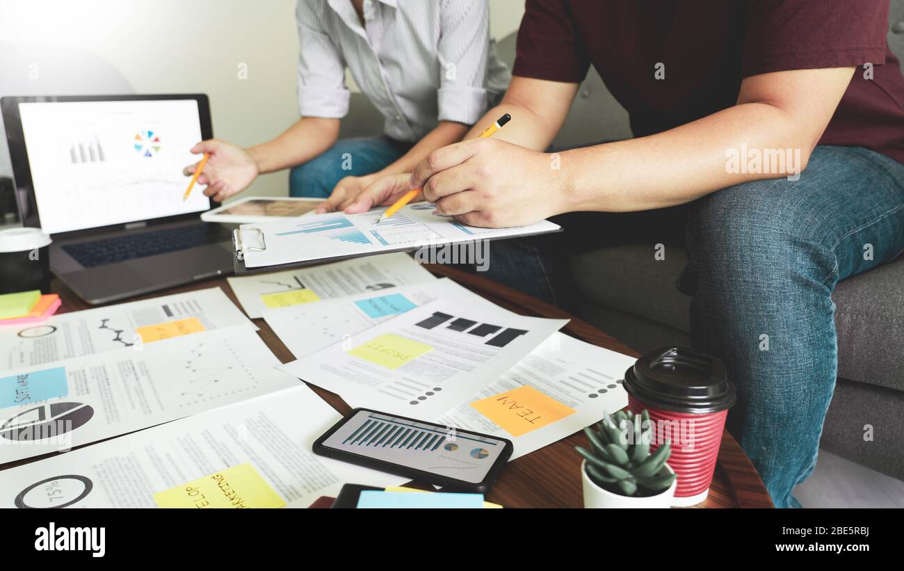 Business people writing on sticky notes for colleagues thinking ...