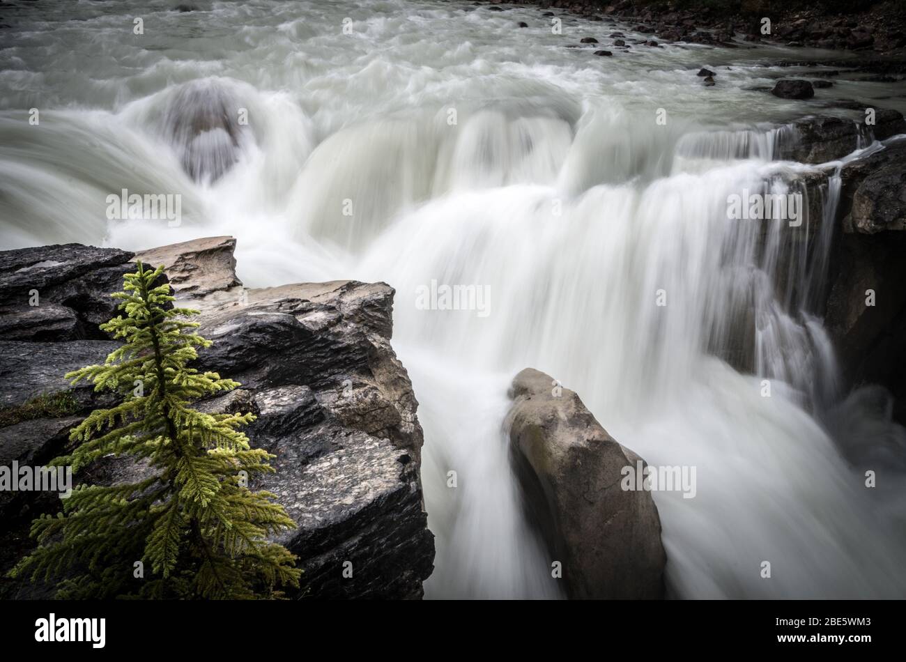 Powerful river waterfall flowing over rocks in British Columbia, Canada ...