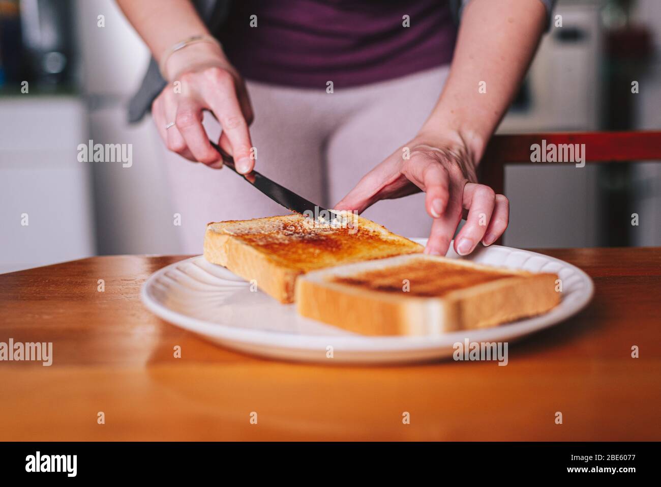 Hands spreading butter toast hi-res stock photography and images - Alamy