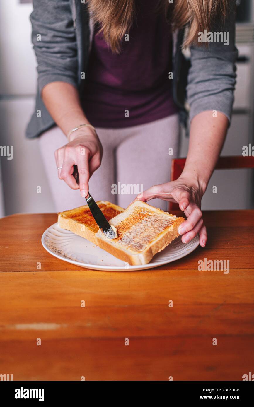 Hands spreading butter toast hi-res stock photography and images - Alamy