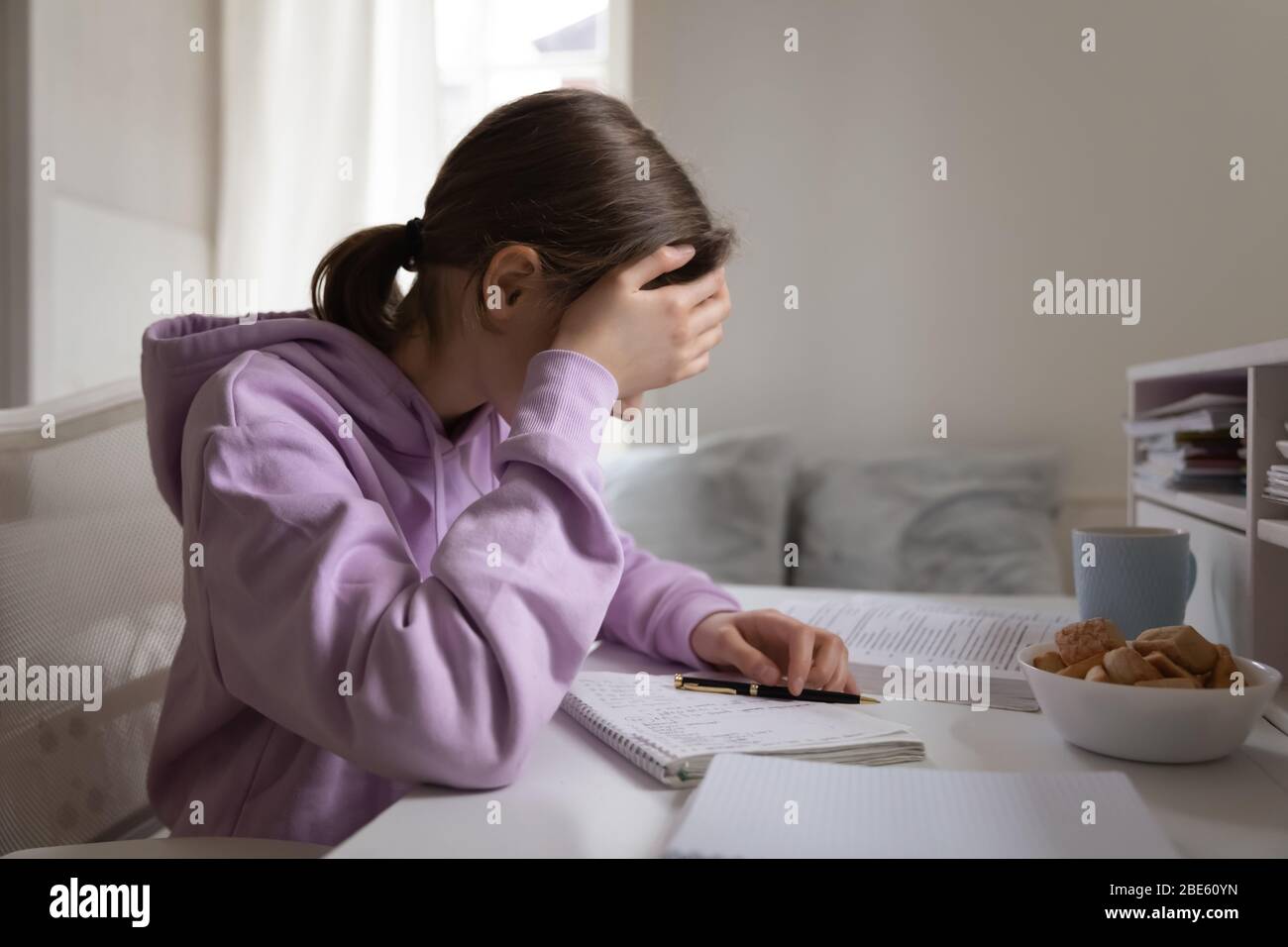 Tired teenage girl school student feeling headache doing homework Stock ...