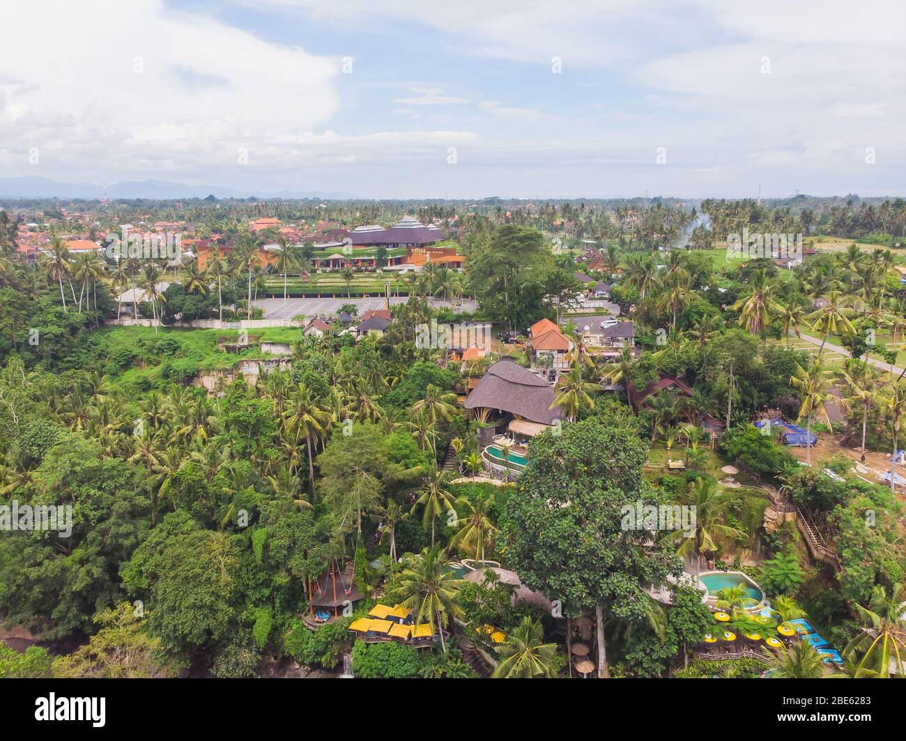 Top down aerial view of rice fields, houses and a road near Ubud in ...