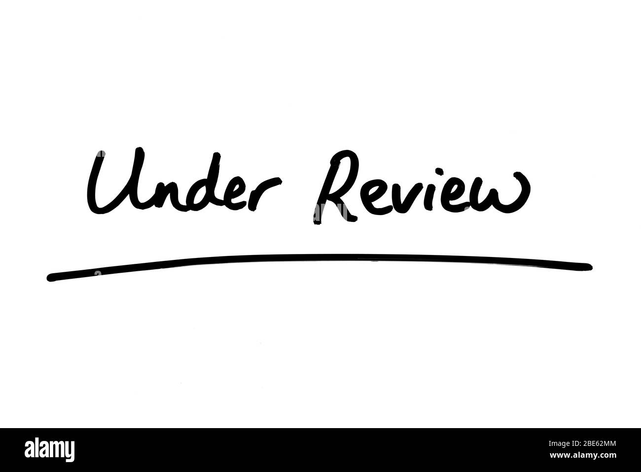 Under Review handwritten on a white background Stock Photo - Alamy