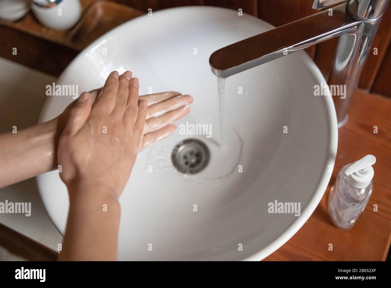 Woman washing hands using soap above bathroom sink, closeup Stock Photo ...