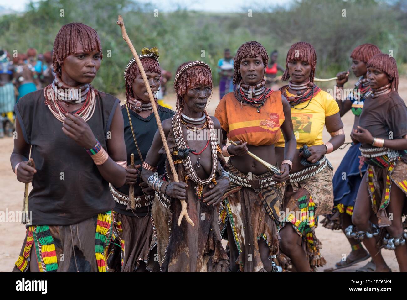 Women dance blow brass horns at Mursi tribe ethnic group coming of age ...
