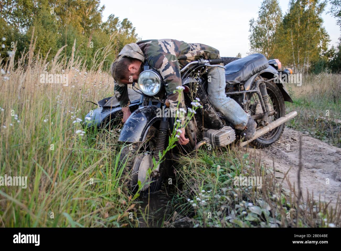 Drunk man in a motorcycle with a sidecar got stuck on the road Stock ...